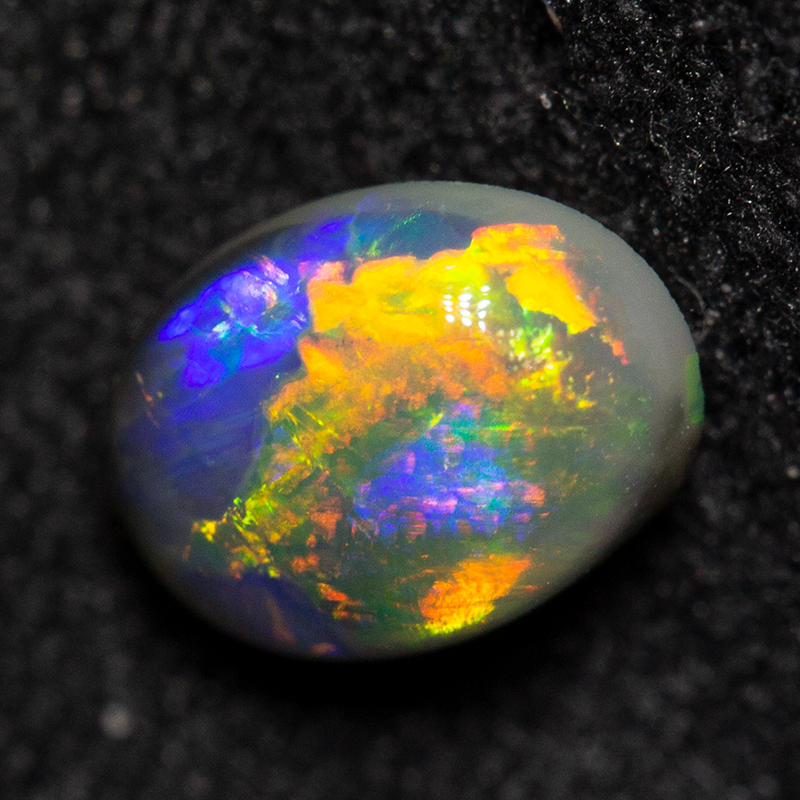 0.58 ct dark opal 6.3x4.7x3.3mm