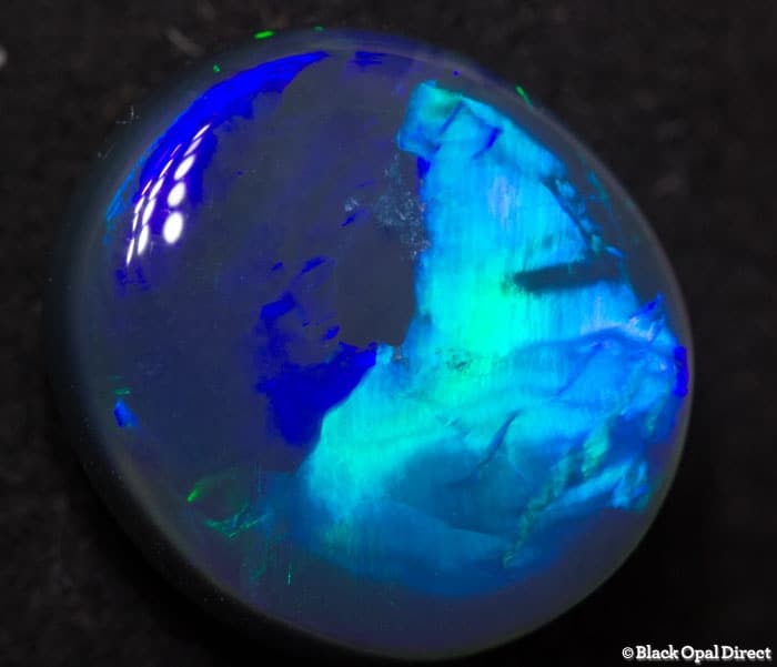 4.84 ct black opal with chinese writing 12.5x11.5x5mm Tim